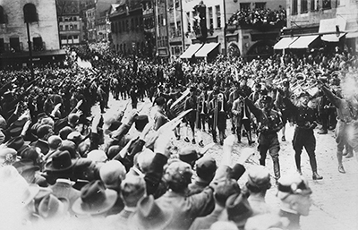 A young Heinrich Himmler gives the Nazi salute as he marches in the ...